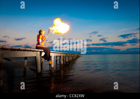 Female fire breather performing at dusk Stock Photo - Alamy