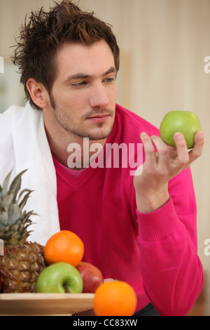 Hand picking apple from bowl of fruit Stock Photo - Alamy