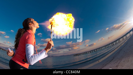 Fire eaters performing on the beach pier, Alcudia at dusk, Majorca ...