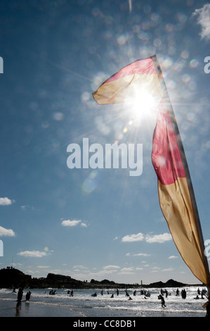 Beach safety flag with the sun shining behind, Bude, Cornwall Stock ...