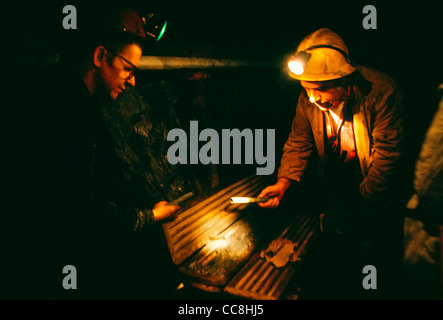 Miner's Lamp in Dark Mine on a Wood Stock Photo - Alamy