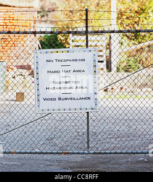 A 'NO TRESPASSING" sign on a chain link gate with a padlock Stock Photo ...