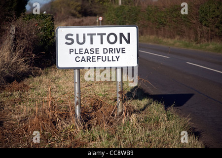 Road sign & 'Please drive carefully' sign at the entrance to the small ...