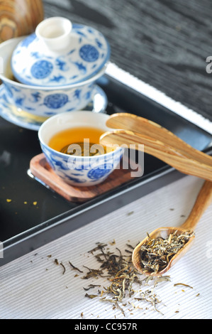 Asian tea set with dried green tea and sugar on wooden background Stock ...