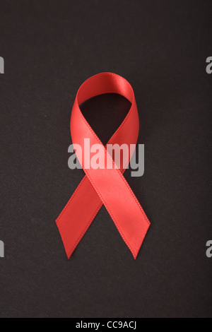 Red bow ribbon symbol HIV, AIDS cancer awareness Stock Photo - Alamy