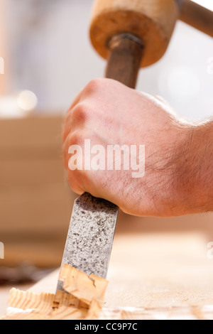 Hands of a carpenter working with chisel and hammer Stock Photo - Alamy