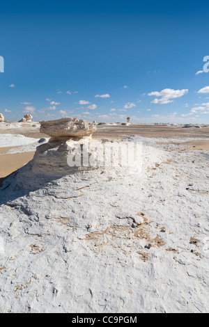 Inselbergs with surrounding ridged sand in the White Desert, close to ...
