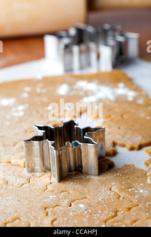 Festive shapes and star cookie cutter on gingerbread cookie dough Stock ...