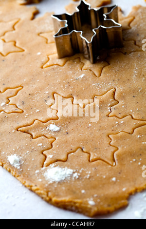 Festive shapes and star cookie cutter on gingerbread cookie dough Stock ...