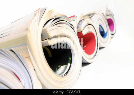 Rolled up magazines over white background Stock Photo - Alamy