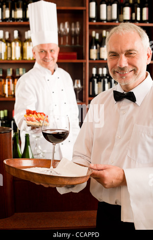 Chef cook and waiter smiling in restaurant wine bar Stock Photo - Alamy