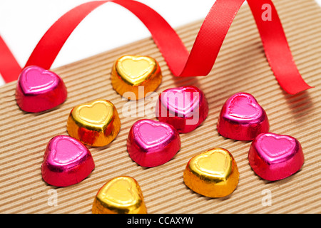 Heart shape chocolate candies wrapped in red foil for Valentine's Day ...