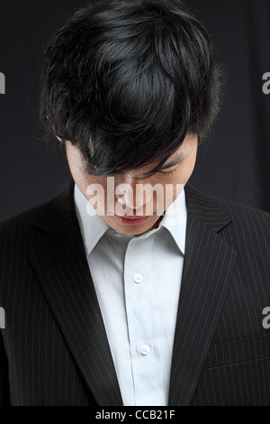 Asian business man looking down the plant seed grow on the desert Stock ...