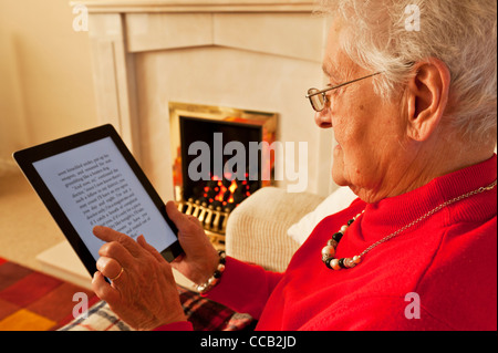 An elderly woman using an iPad Stock Photo: 56671184 - Alamy