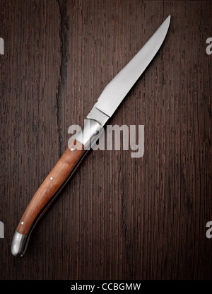 kitchen knife on brown wooden table Stock Photo - Alamy