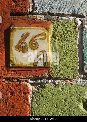 house home street number 46 a name plate design on brick wall in sun ...