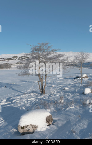 Loch Tulla and snow-covered mountains in the Scottish highlands, from a ...