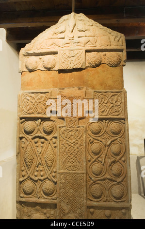 Ancient stone slab with carved Celtic Cross design, on the shores of ...