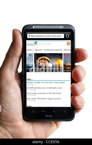 Close up shot of a mobile phone with broken screen on a wooden table ...