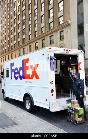 FedEx Express delivery truck unloading at receiving dock of commercial ...