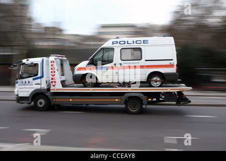 Van recovery truck carrying broken down 1999 Jaguar XKR Auto; Side view ...