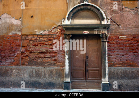 very old wooden door and rundown brick wall Stock Photo - Alamy