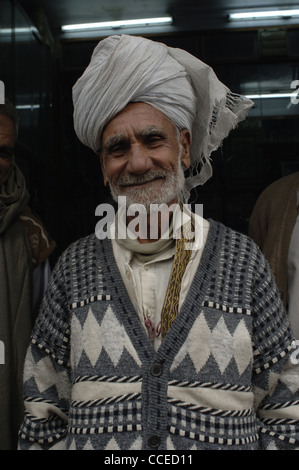 Elderly smiling kindly man in red sweater on a red background Stock ...