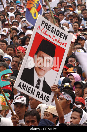 A supporter holds a poster of presidential candidate Ivan Cepeda of the ...