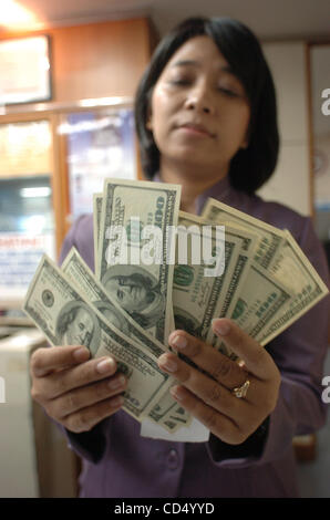 Tellers count of US dollar from a customer at Money Changer in Stock ...