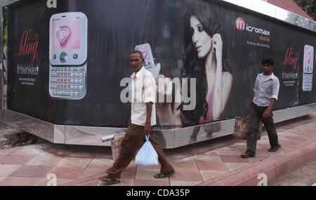 Aug 03, 2010 - Mumbai, India - A man walks past a billboard add for ...