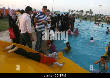 Palestinians enjoy swimming in a pool at the newly-opened "Asda City ...