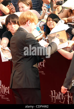 Rupert Grint signs autographs for fans at the premiere of "Harry Potter ...