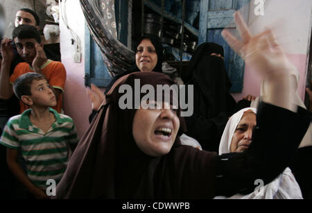 A relative of Palestinian Hisham Abu Harb mourns during his funeral in ...
