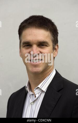 Los Angeles Kings' Luc Robitaille proudly displays the Calder Trophy as ...