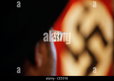 A Haredi Jew looks at an exhibit of Nazi swastikas in Yad Vashem, the ...