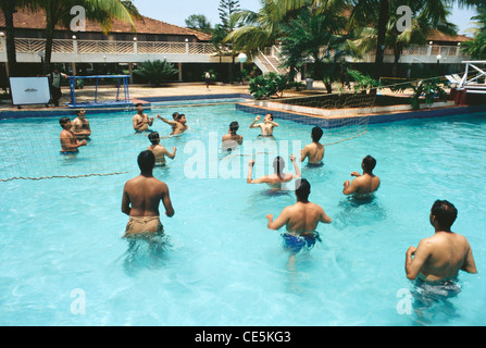 Tourists playing on volley ball court next to the beach road in Roda ...
