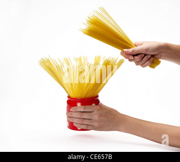 Hand full of raw dry spaghetti, close up view Stock Photo - Alamy
