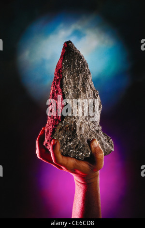Hand holding stone Stock Photo - Alamy