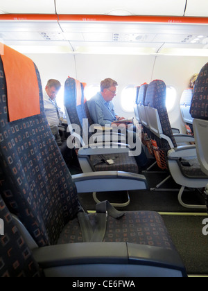 Interior of Easy Jet easyjet plane airplane with passengers seated ...