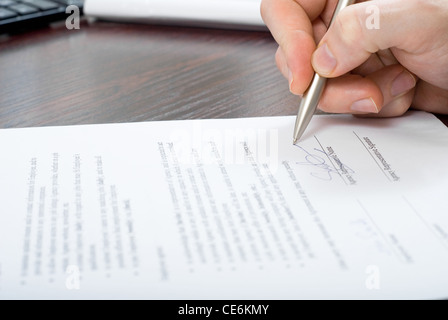 Close up shoot of signing contract by a businessmen with silver pen ...