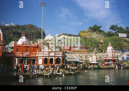 People at a bathing ghat, India. A ghat is a series of steps leading ...