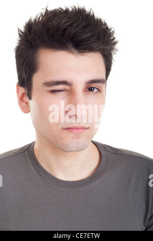 Confident handsome Caucasian man winking and smiling at camera on blue ...