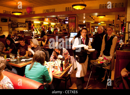People eating inside Frankie & Bennys restaurant bar, Cambridge UK ...