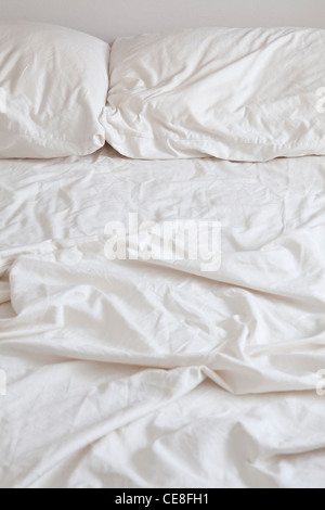 Empty bed with disheveled pillows and sheets Stock Photo - Alamy