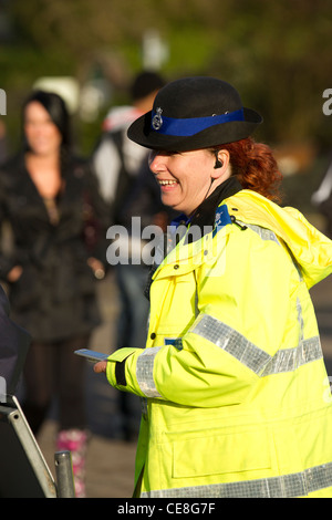 Smiling female police community support officer and laughing male ...