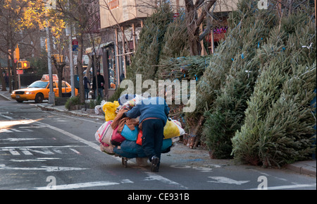 Homeless man pushing trolley with his belongings through lower Stock ...