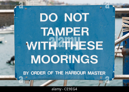 'Do Not Tamper With These Moorings' sign with boats in the background ...