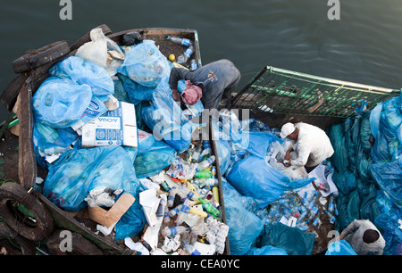 Garbage barge collects the rubbish from cruise ships, River Nile, Luxor ...