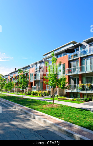 Row of new residential townhouses on a street. Family townhouses with ...
