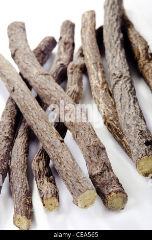 Dried sticks of liquorice root on white background Stock Photo - Alamy